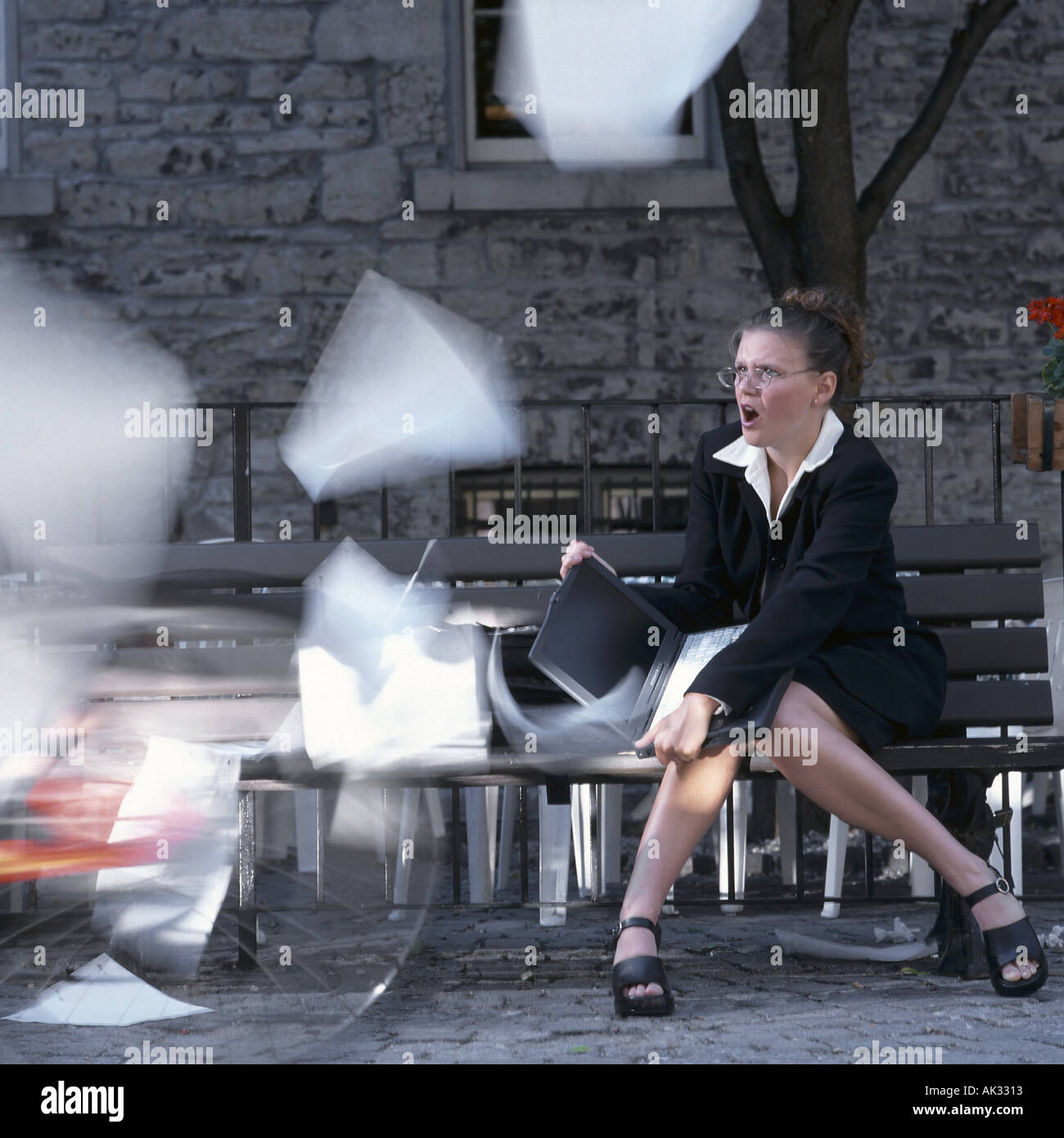 Business woman sitting on bench with documents flying through th Stock ...