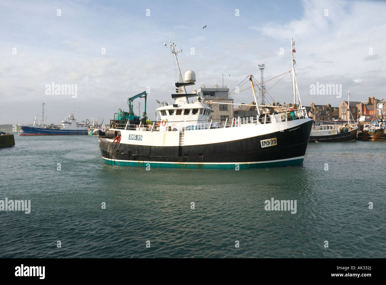 Fishing boat entering Peterhead harbour to land its catch Stock Photo ...