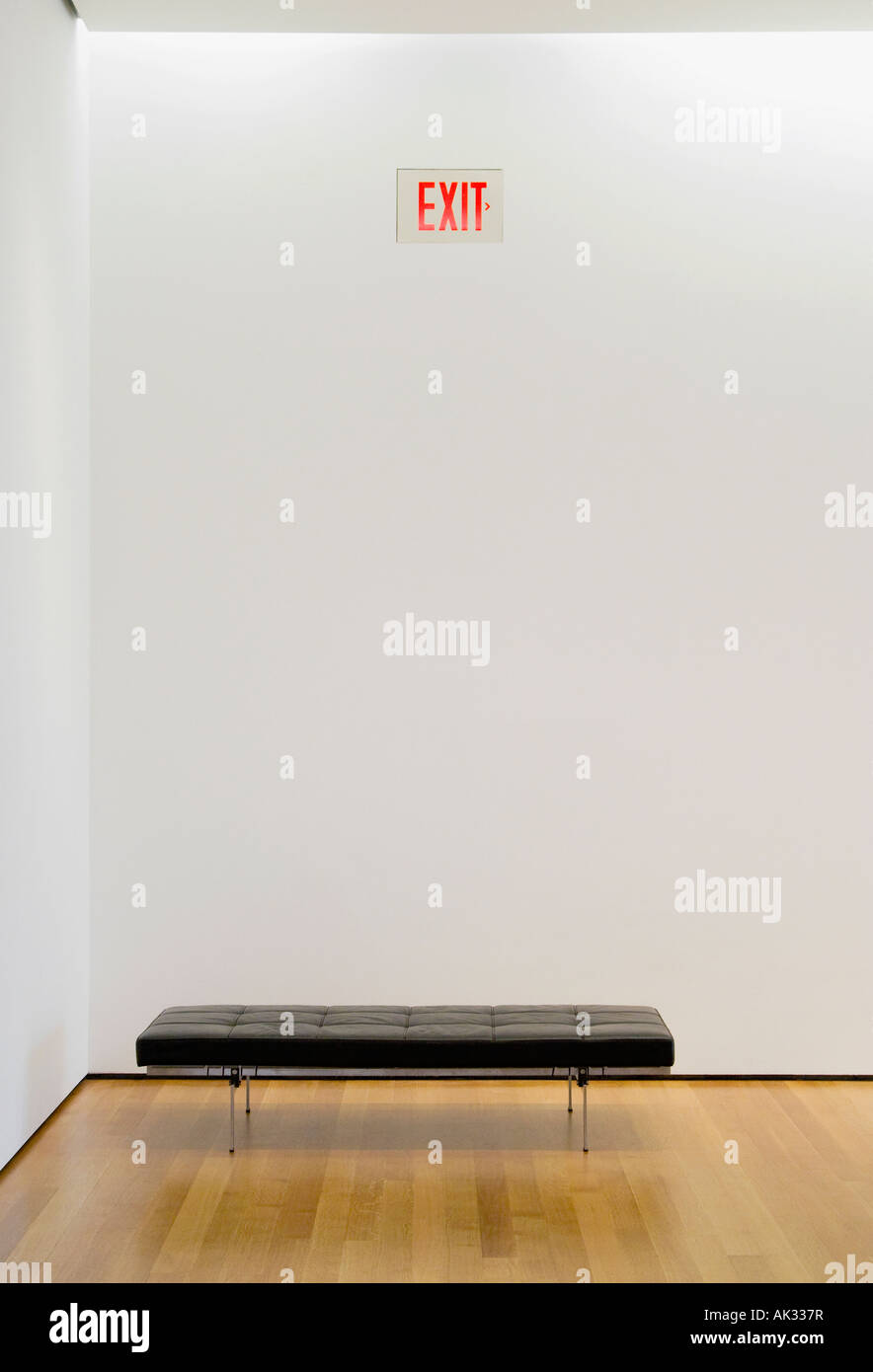 red exit sign over contemporary couch in large room Stock Photo - Alamy