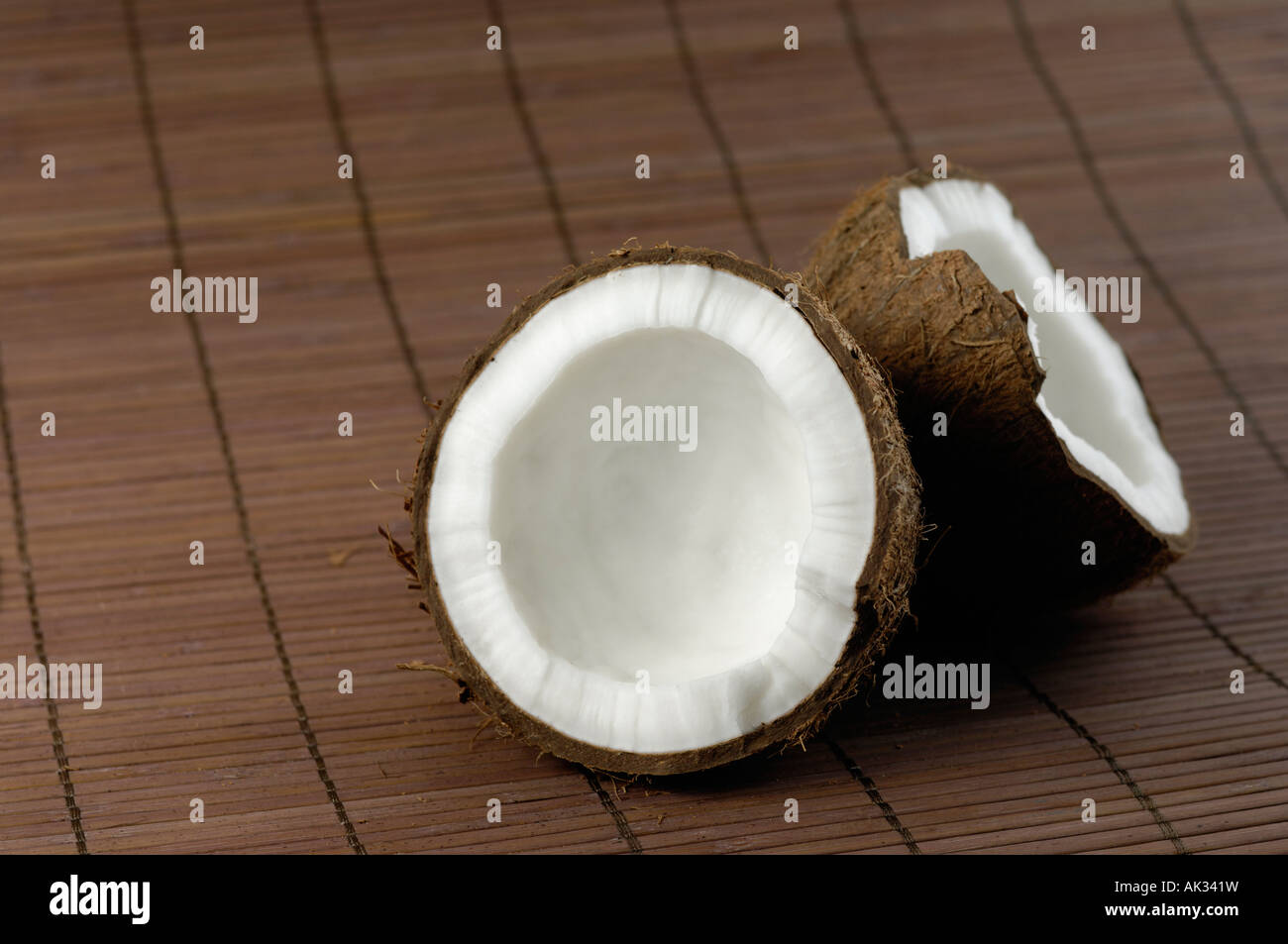 Coconut cracked in two halves Stock Photo - Alamy