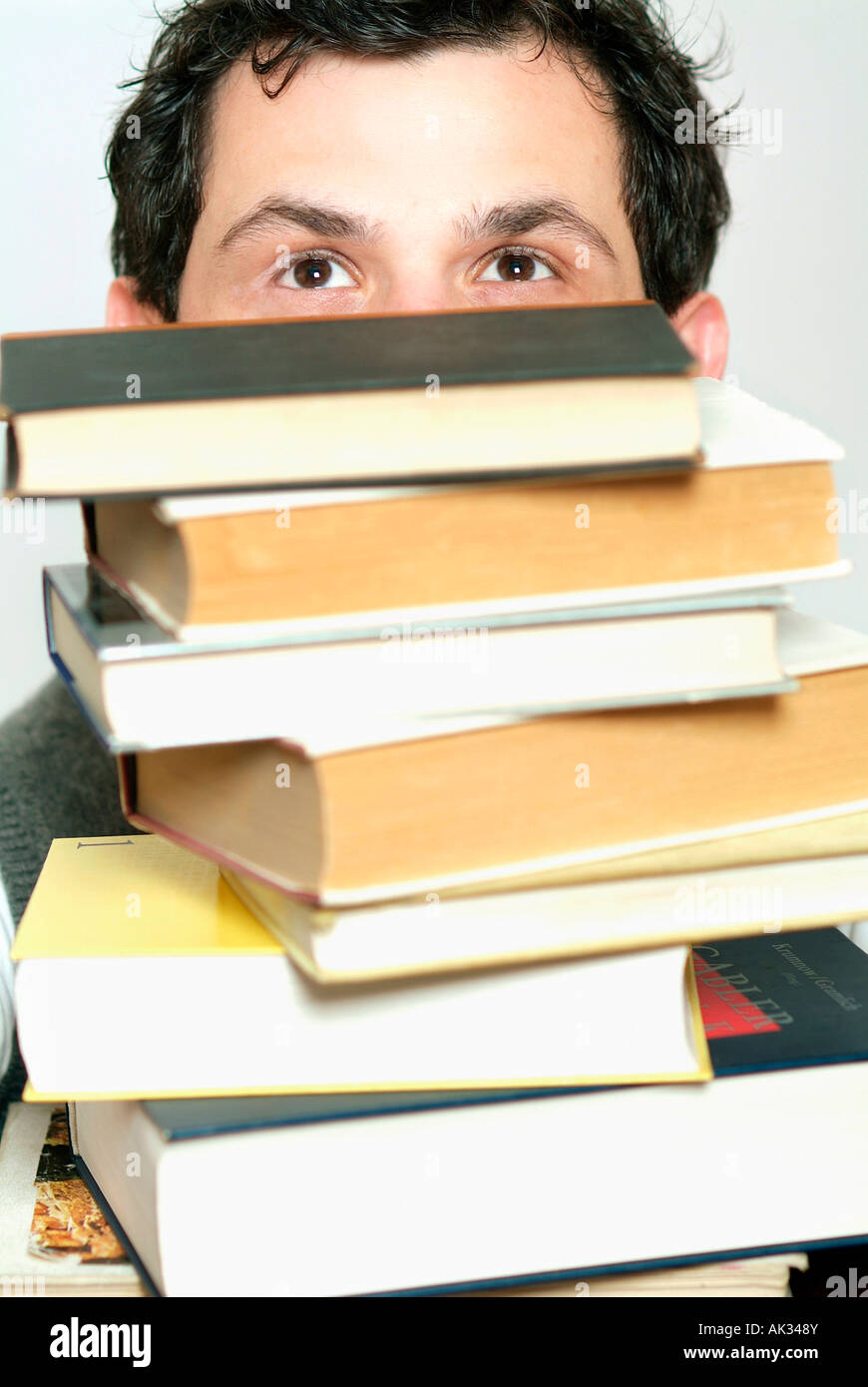 Man hidden behind books Stock Photo - Alamy