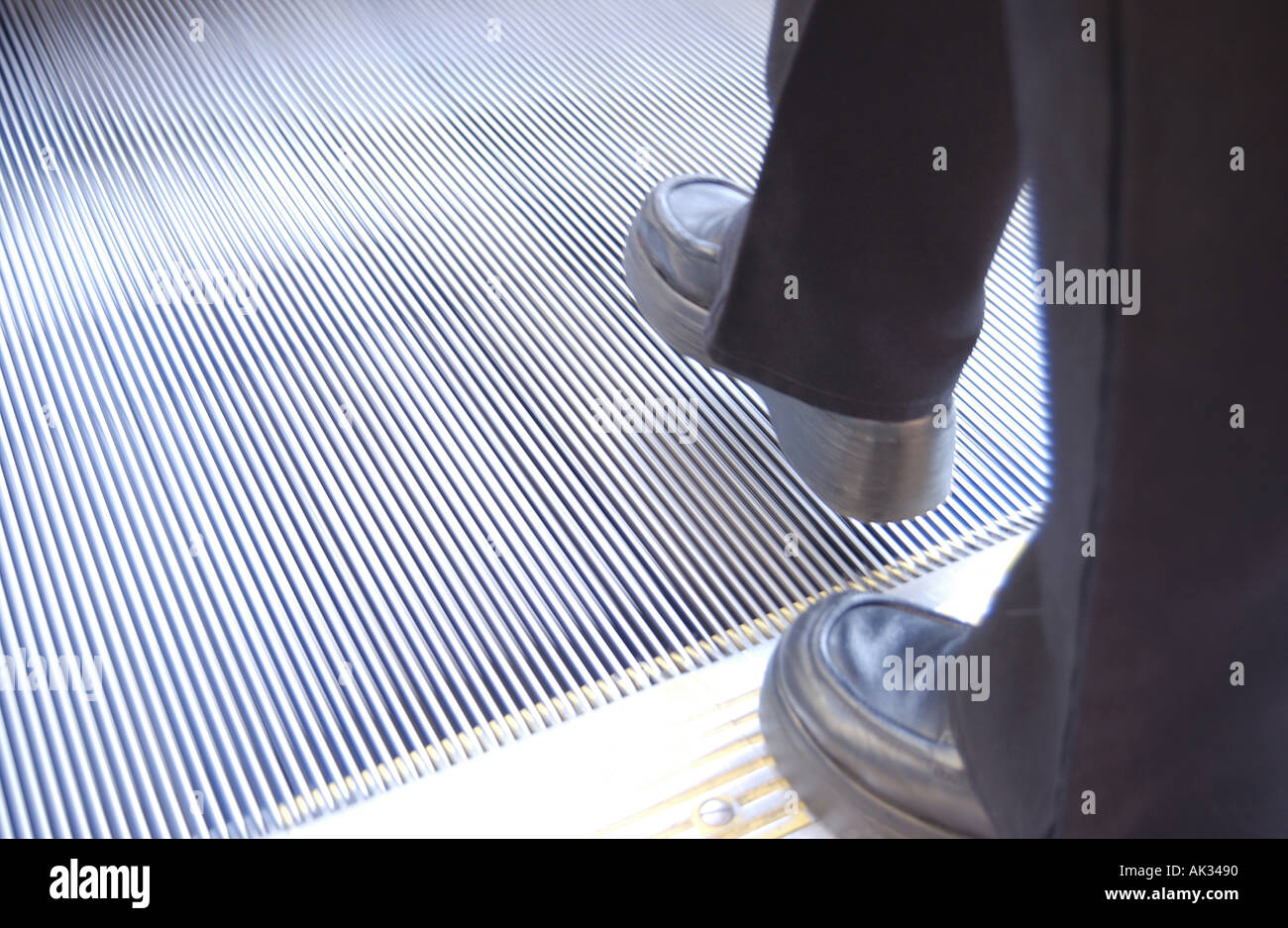 Man stepping onto escalator Stock Photo - Alamy
