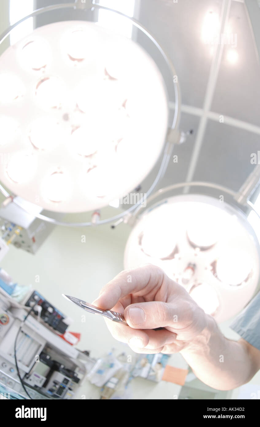 Surgeon holding scalpel in operating room Stock Photo - Alamy