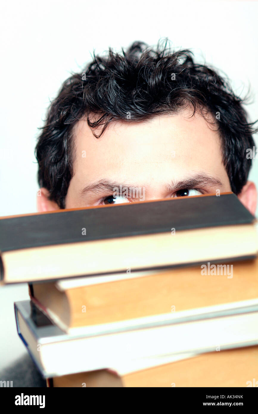 Man hidden behind books Stock Photo - Alamy
