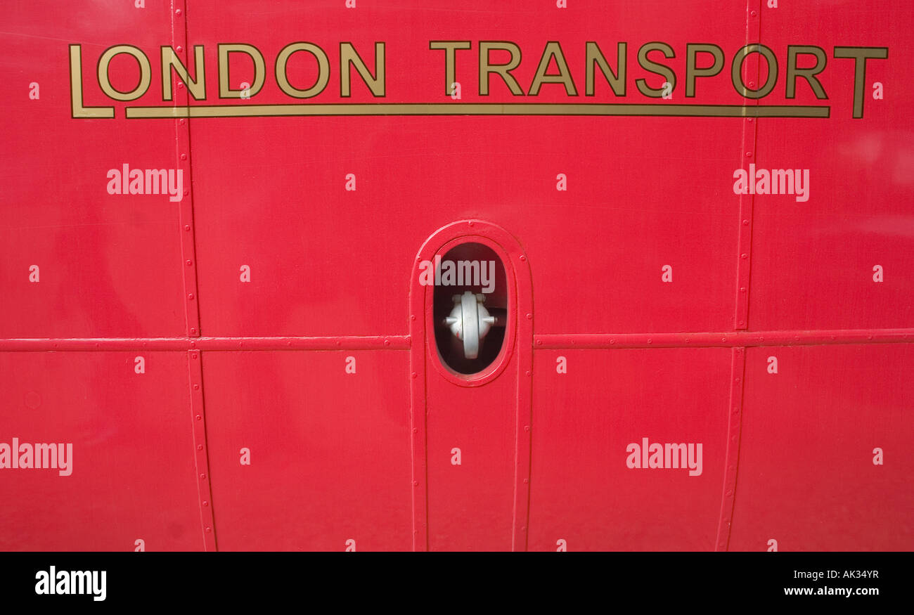 Closeup of the side of an old-fashioned single decker red London Bus ...
