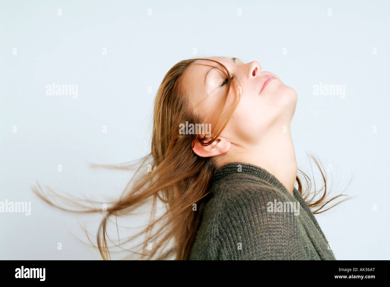 Young woman swinging her hair back Stock Photo - Alamy