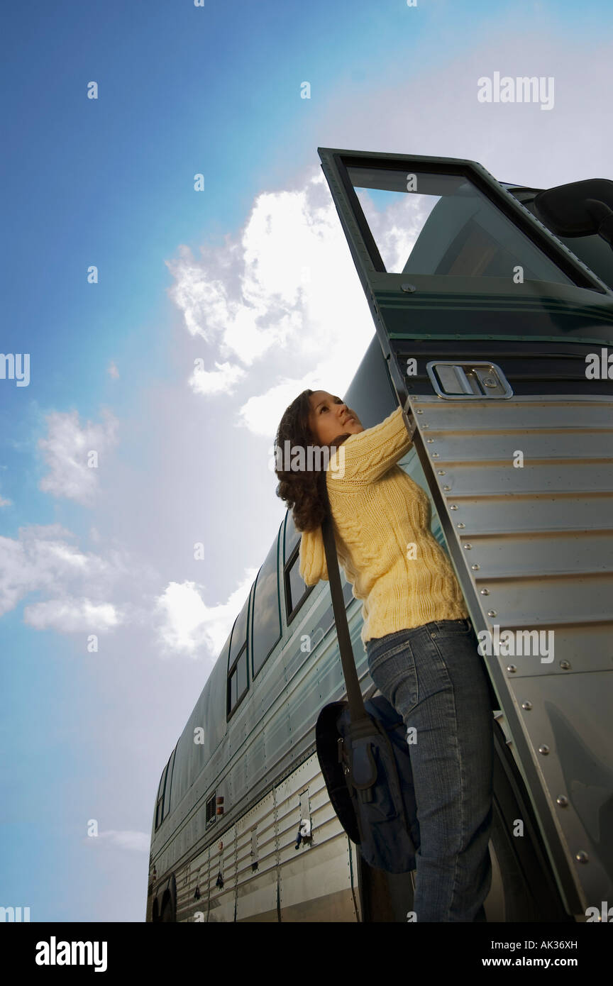 Woman climbing on a bus Stock Photo - Alamy