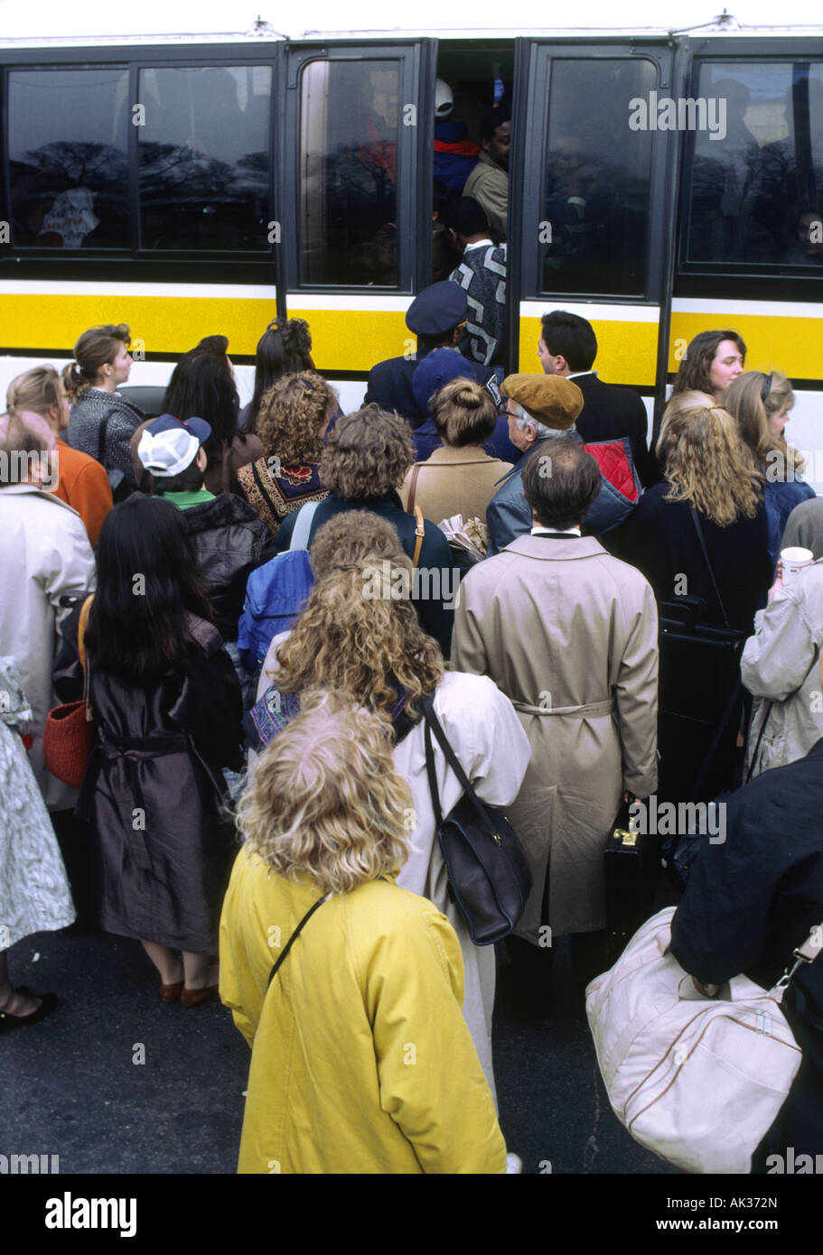 Commuters line up queue to board a public bus Stock Photo - Alamy