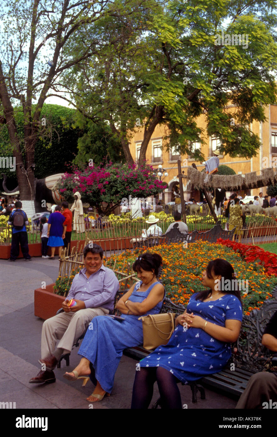 Mexican people, friends, sitting on bench, Jardin Zenea, city of ...