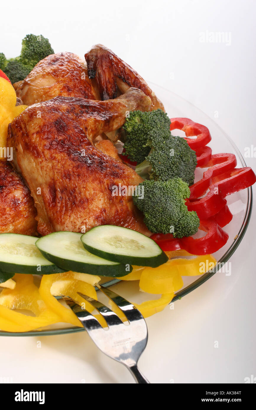 Roasted chicken meat served on a glass plate with vegetable garnish ...