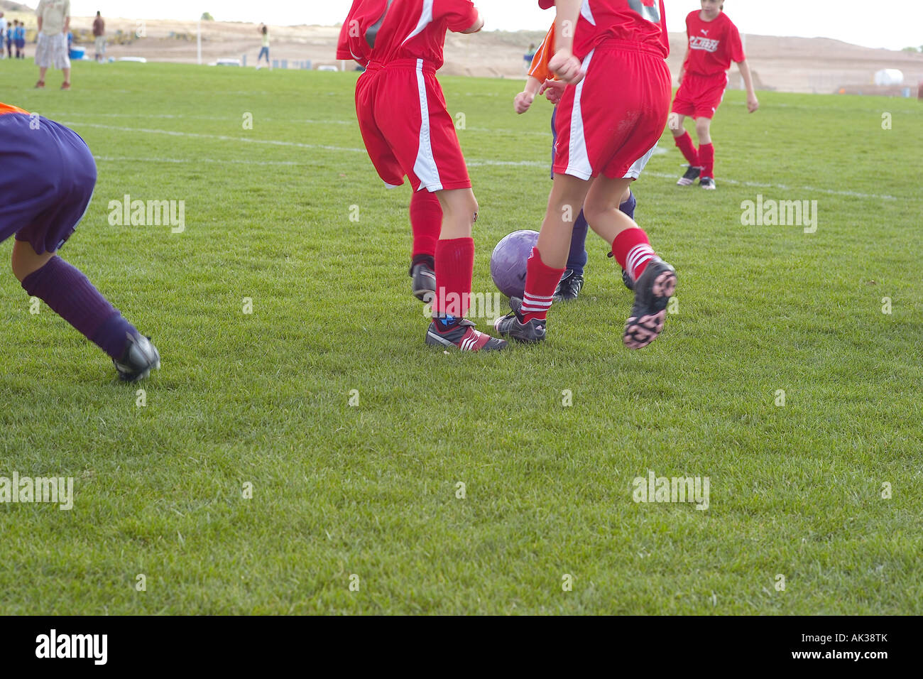 Girls playing soccer on green field outdoors in the Spring Stock Photo ...