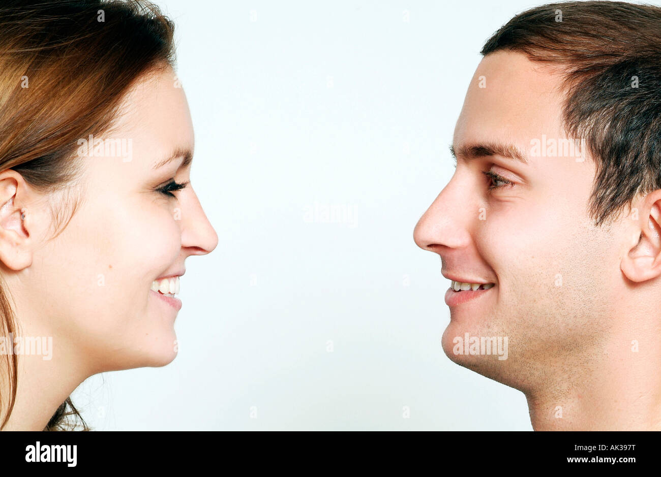 Man and woman smiling at each other Stock Photo - Alamy