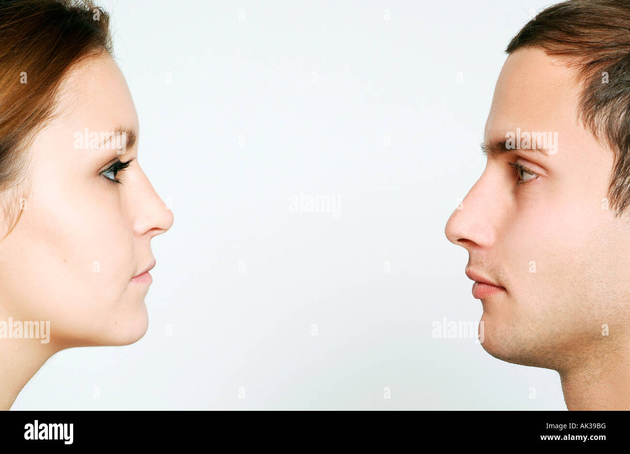 Couple facing each other with a serious look Stock Photo - Alamy