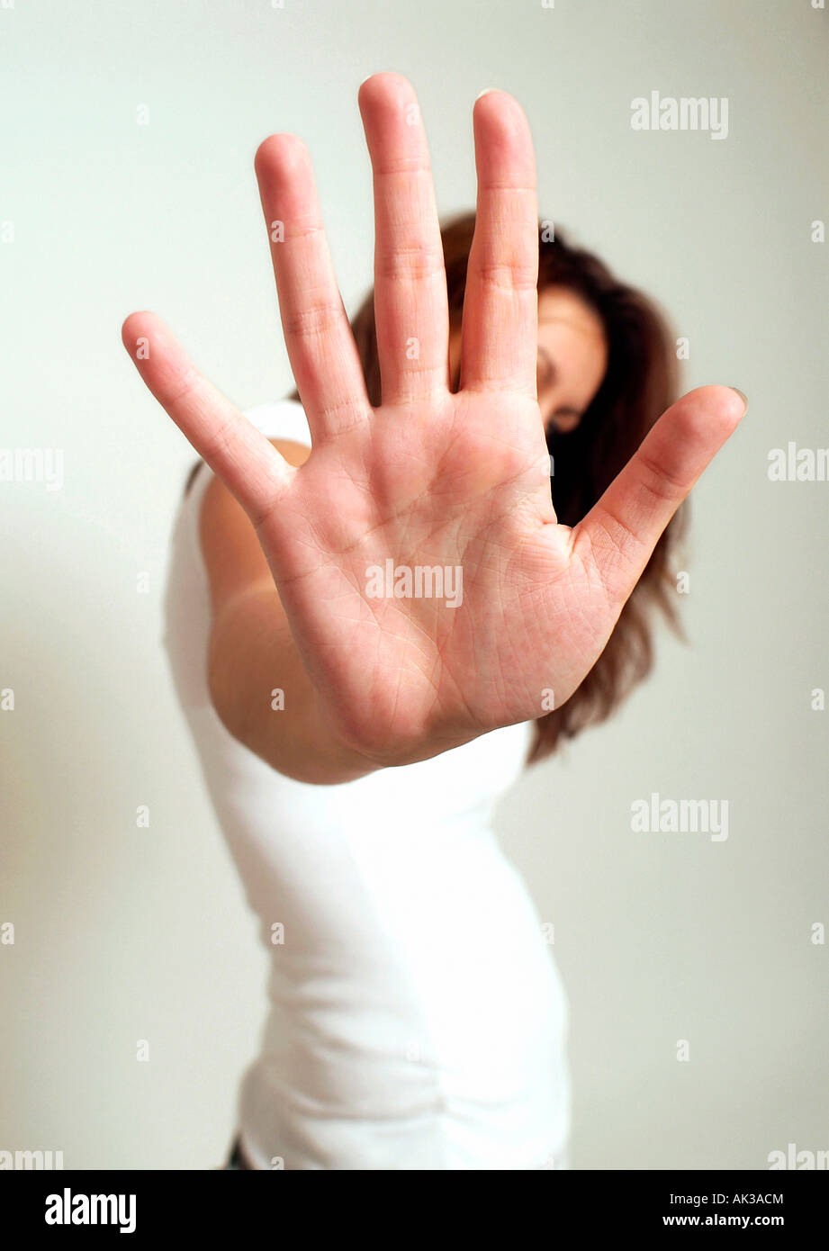 Woman giving a sign to stay away Stock Photo - Alamy
