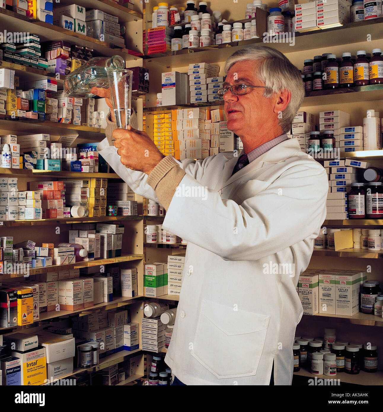 Pharmacist mixing medicine in store room Stock Photo - Alamy