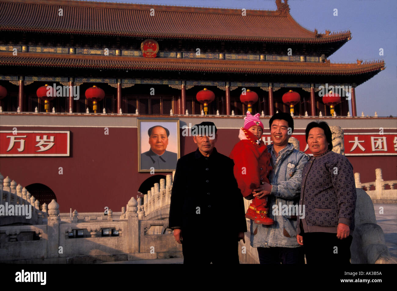 Family of three generations take picture with Tian An Men Tower Beijing ...