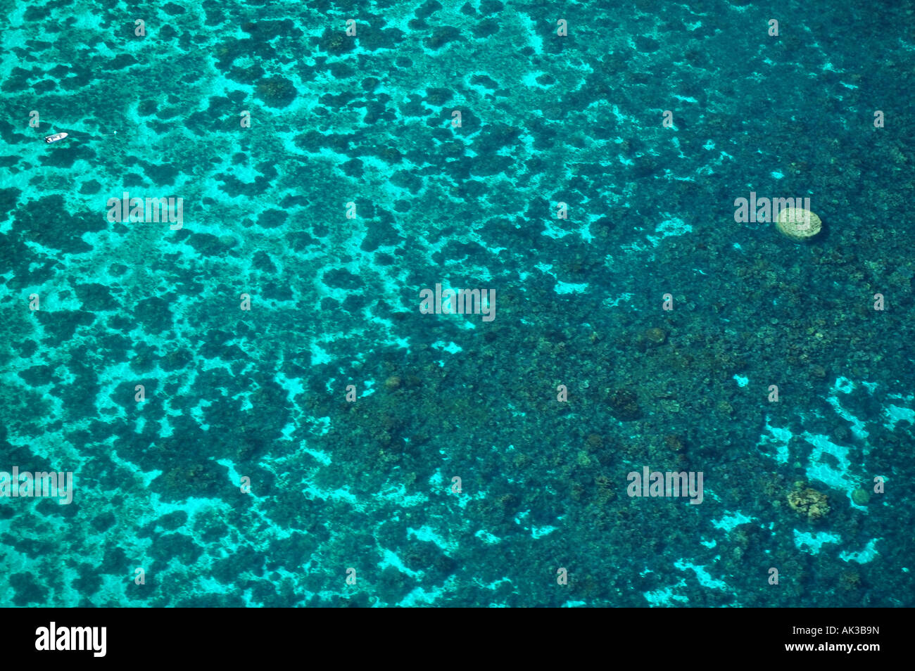 Aerial view of coral reefs and small boat, Coral Bay, Ningaloo Reef ...