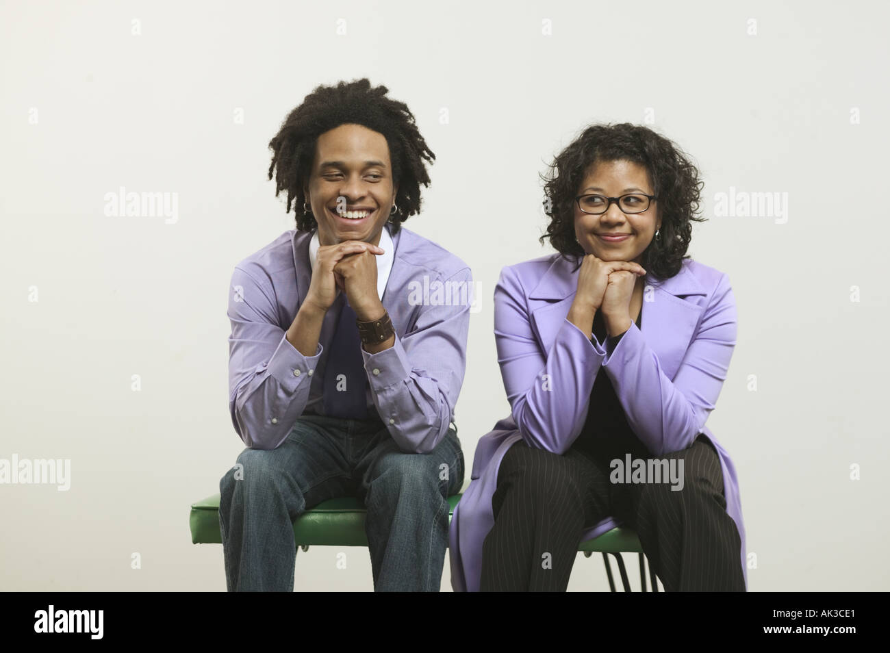 Young couple seated side by side Stock Photo - Alamy