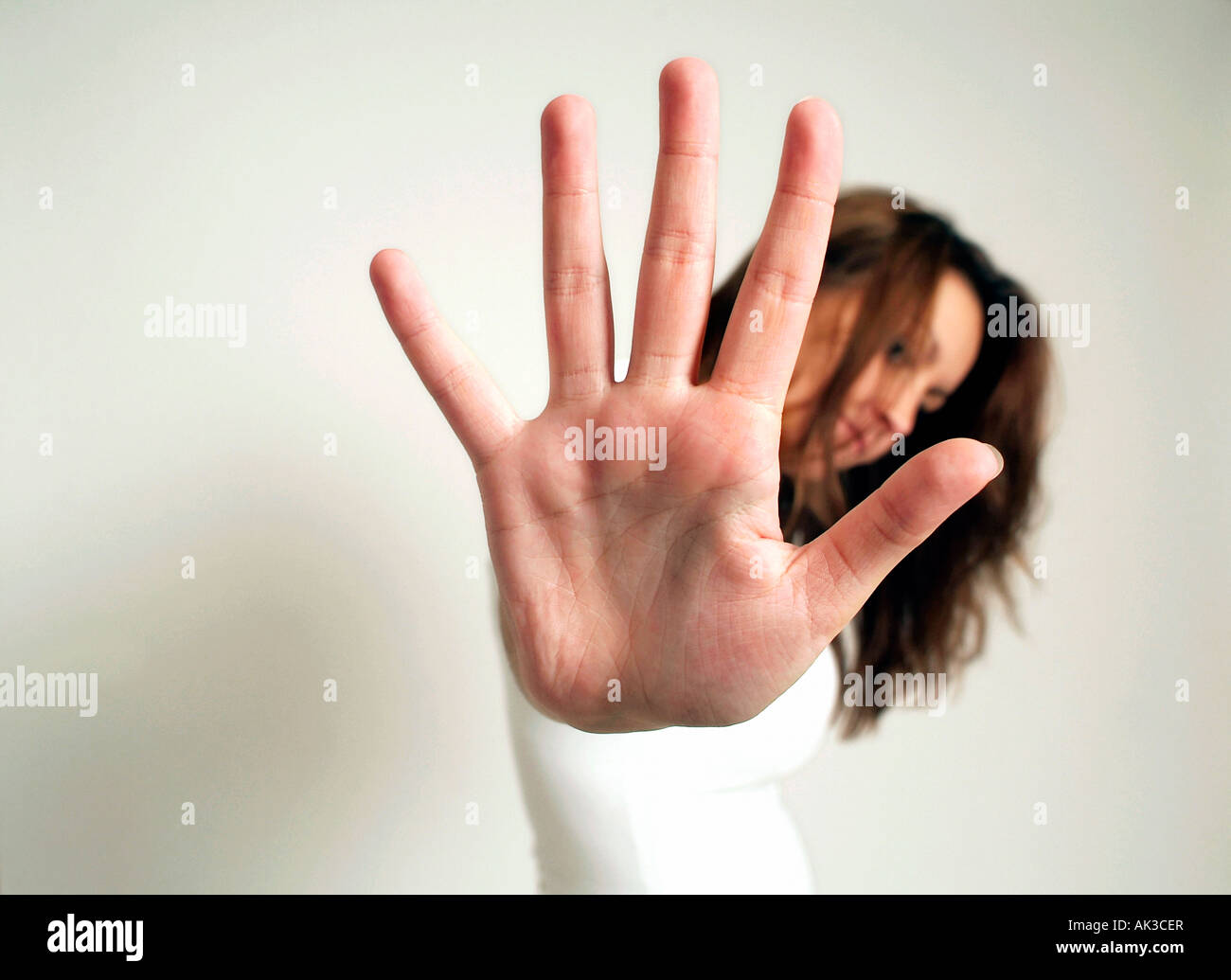 Woman giving a sign to stay away Stock Photo - Alamy