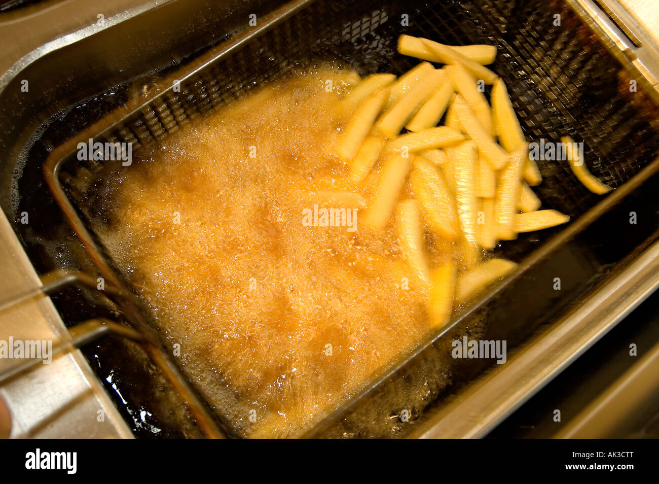 deep fryed chips being deep fried for eating Stock Photo - Alamy