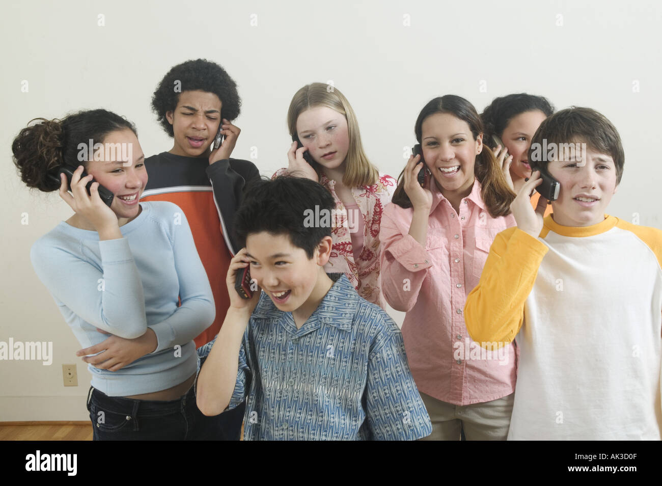 Seven teenagers talking on mobile phones Stock Photo - Alamy
