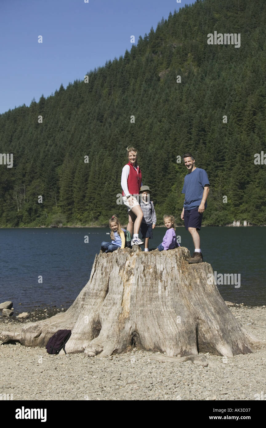 Family posing on a big tree stump Stock Photo - Alamy
