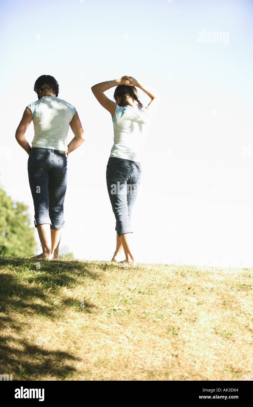 Teenage twins waling up a hill Stock Photo - Alamy