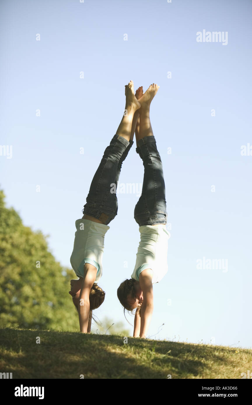 Twin teenage girls doing back to back handstands Stock Photo - Alamy Twin teenage girls doing back to back handstands Stock Photo - Alamy