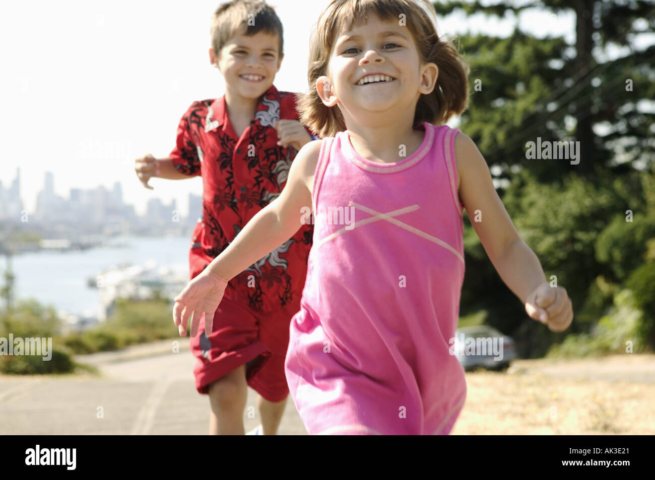 A young boy runs after his little sister Stock Photo - Alamy
