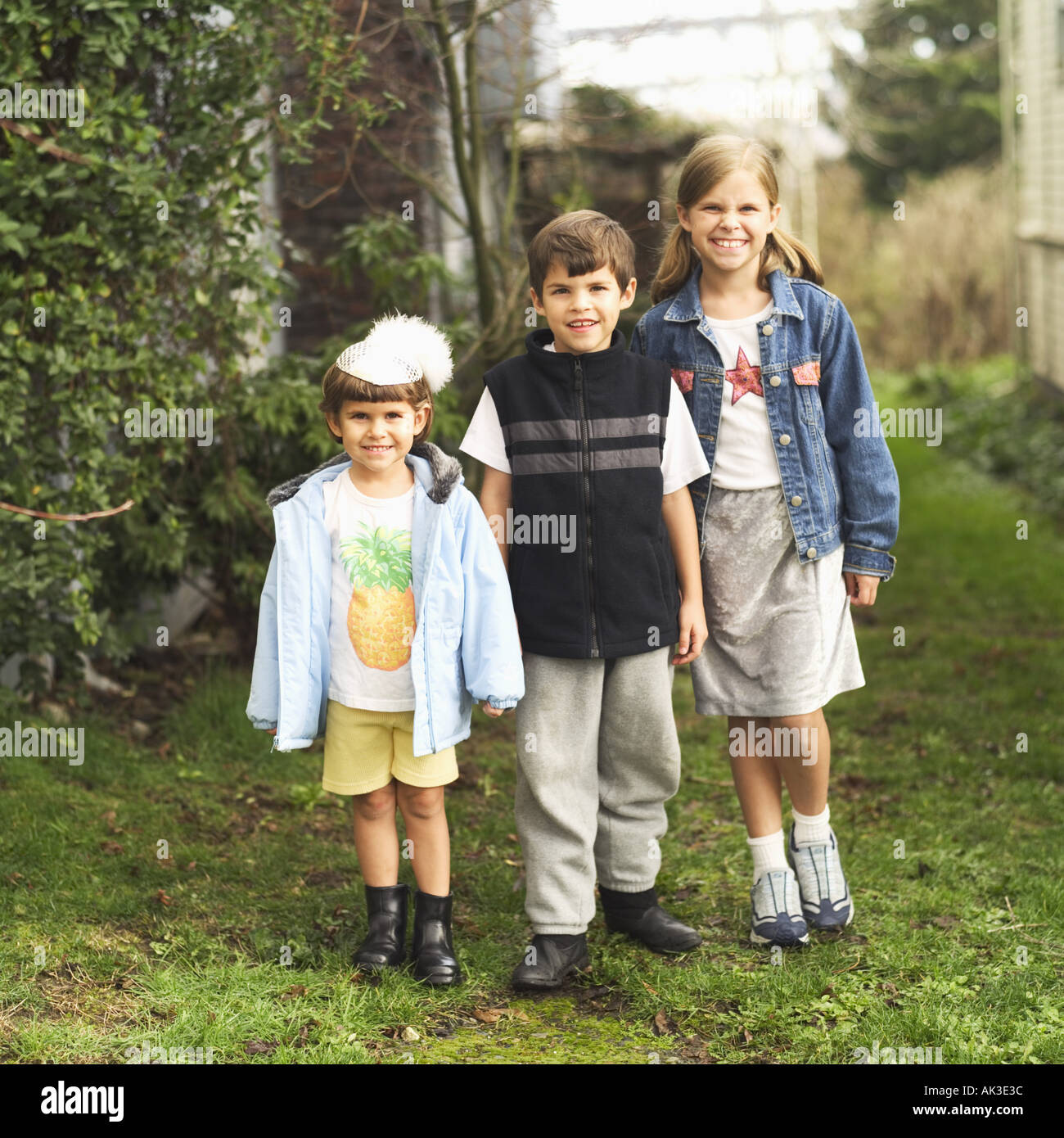 Portrait of three young siblings outdoors Stock Photo - Alamy