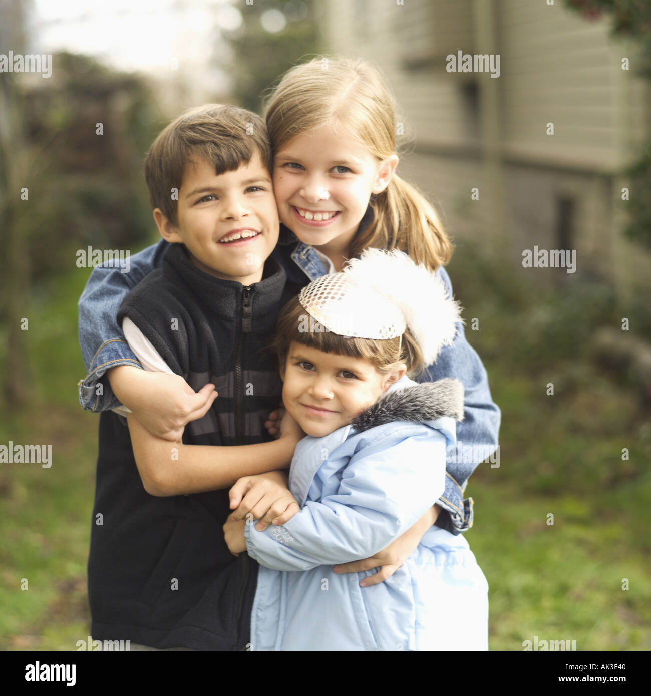 Portrait of three young siblings outdoors Stock Photo - Alamy