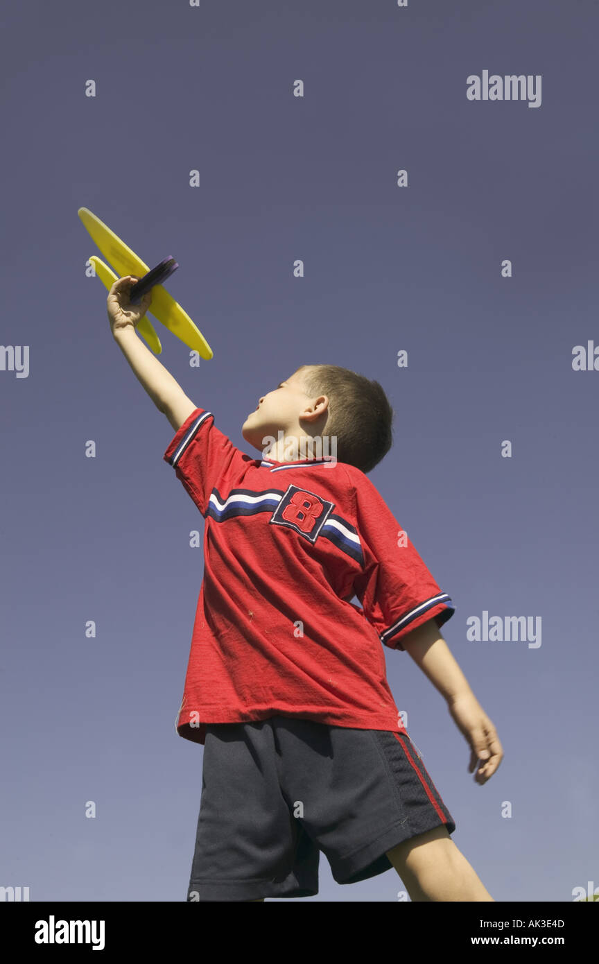 Young boy flying a model airplane Stock Photo - Alamy