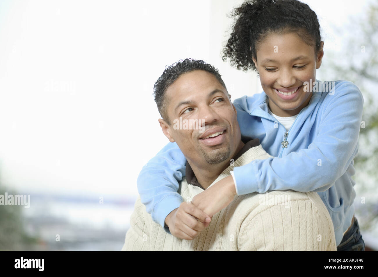 Teenage girl gives her father a hug Stock Photo - Alamy