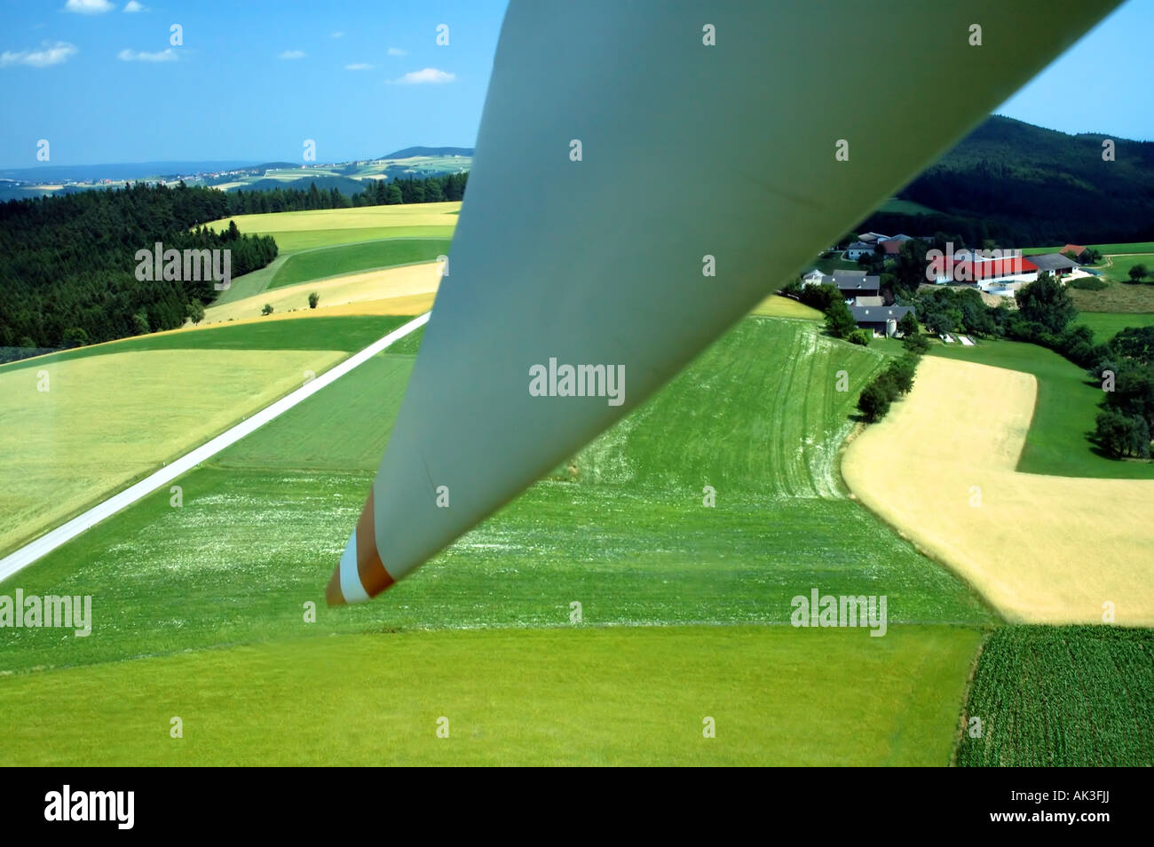 Wind turbine blade passing across rural scene View from public platform ...