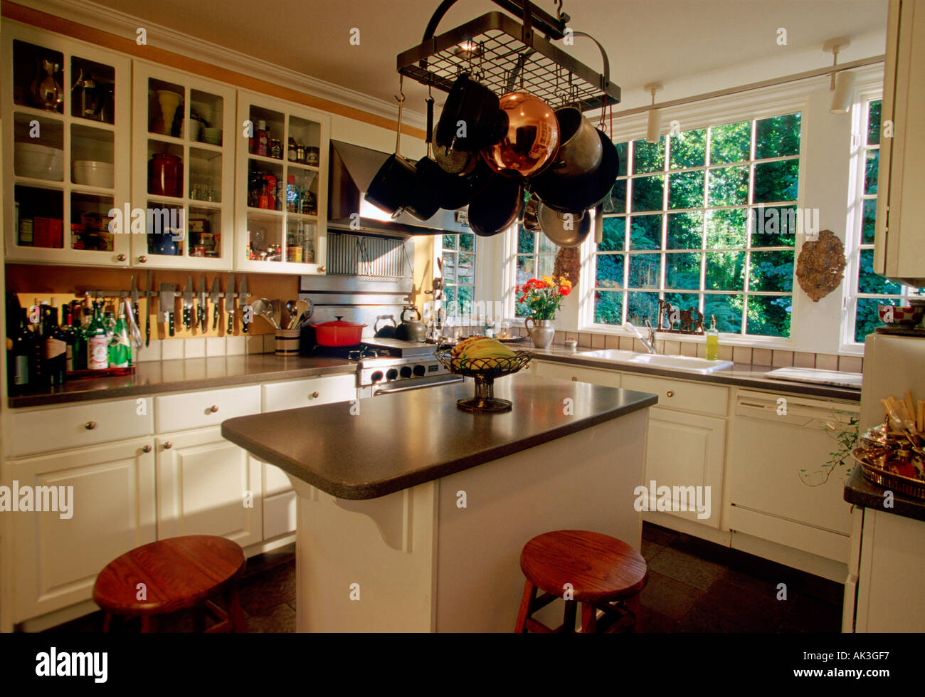 Afternoon sunshine pours through windows into a modern kitchen Stock ...