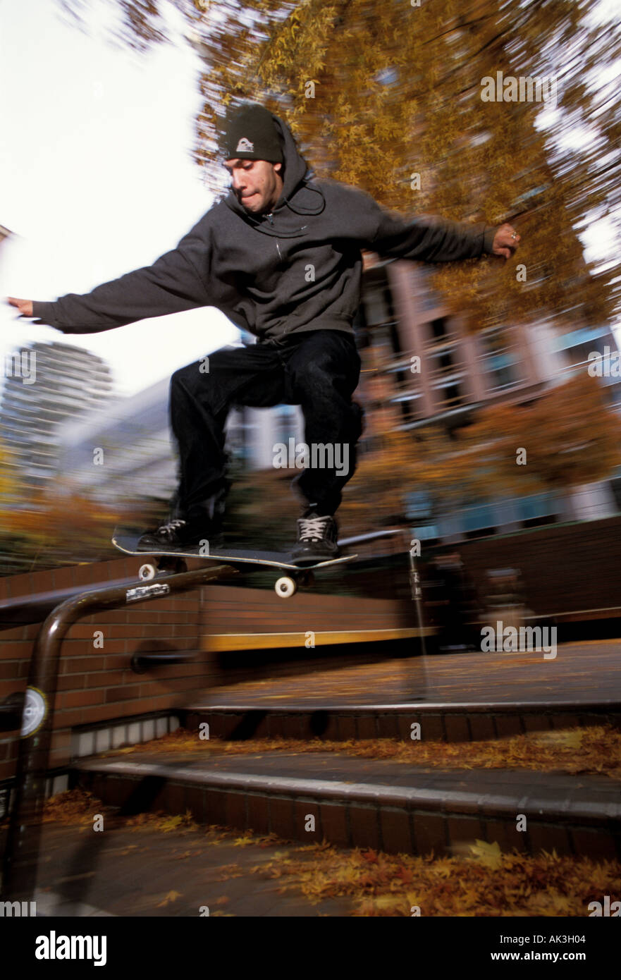 A skateboarder takes his board on a dangerous ride down a hand rail ...
