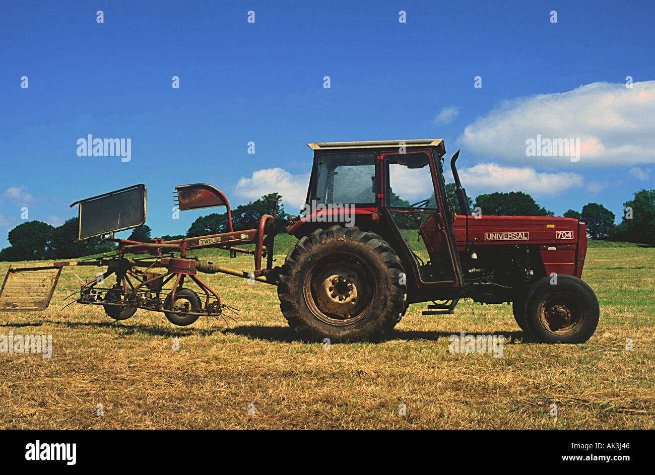 Tractor with rake Stock Photo - Alamy