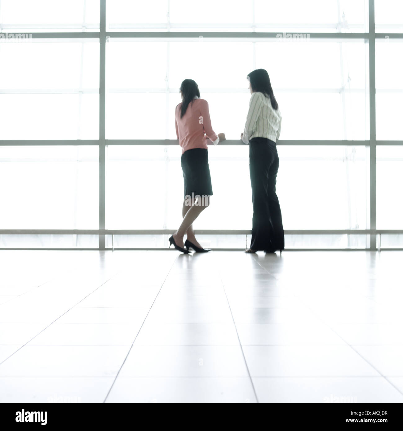 Two women standing tall window hi-res stock photography and images - Alamy