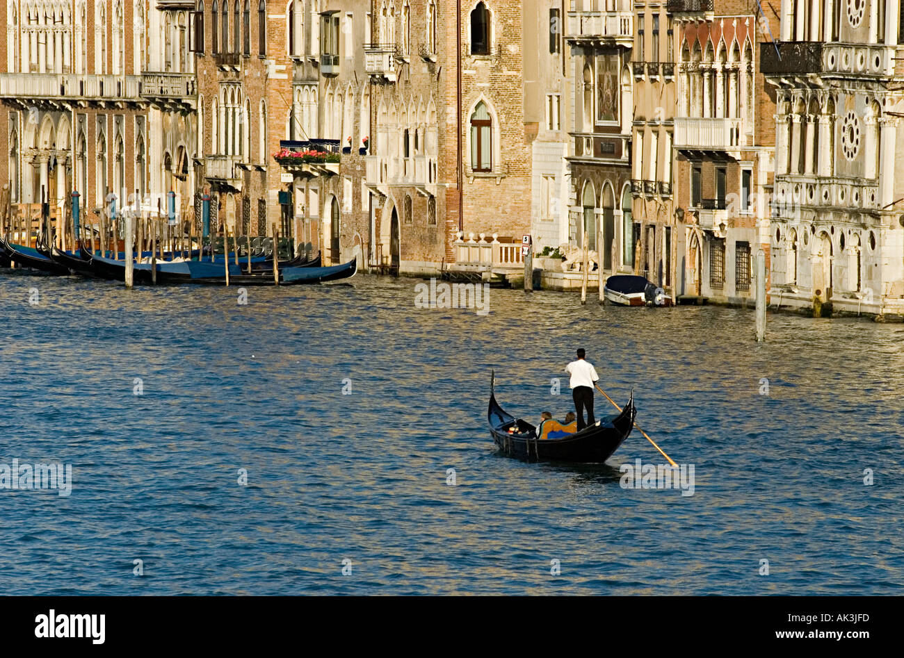 Old buildings and palazzos along the Grand Canal Venice with gondola ...
