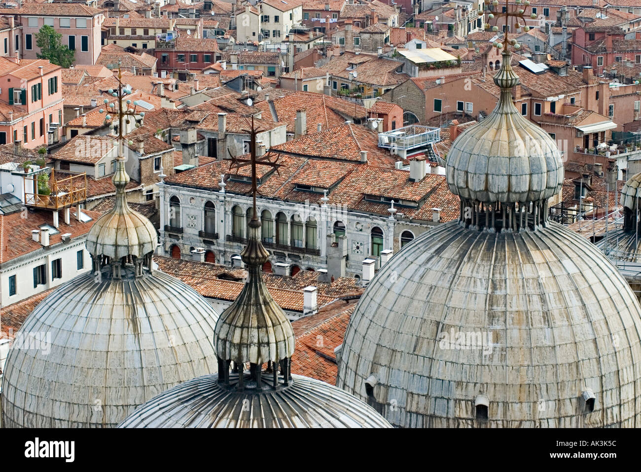 Red tiled rooves of builduings seen beyond the domes of San Marco from ...