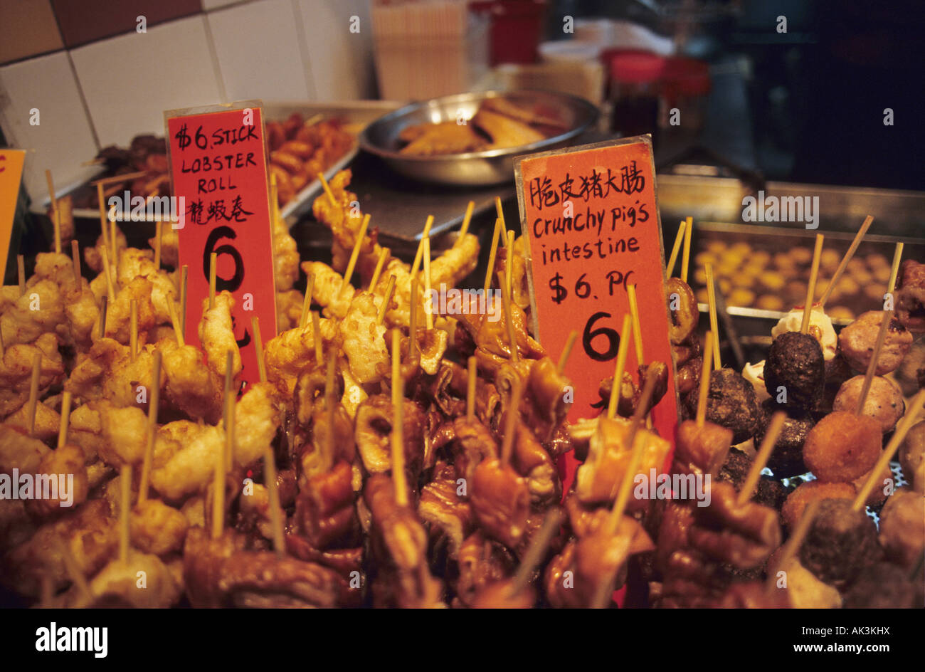 A sign saying crunchy fried pigs intestines at a Chinese hot food stall ...