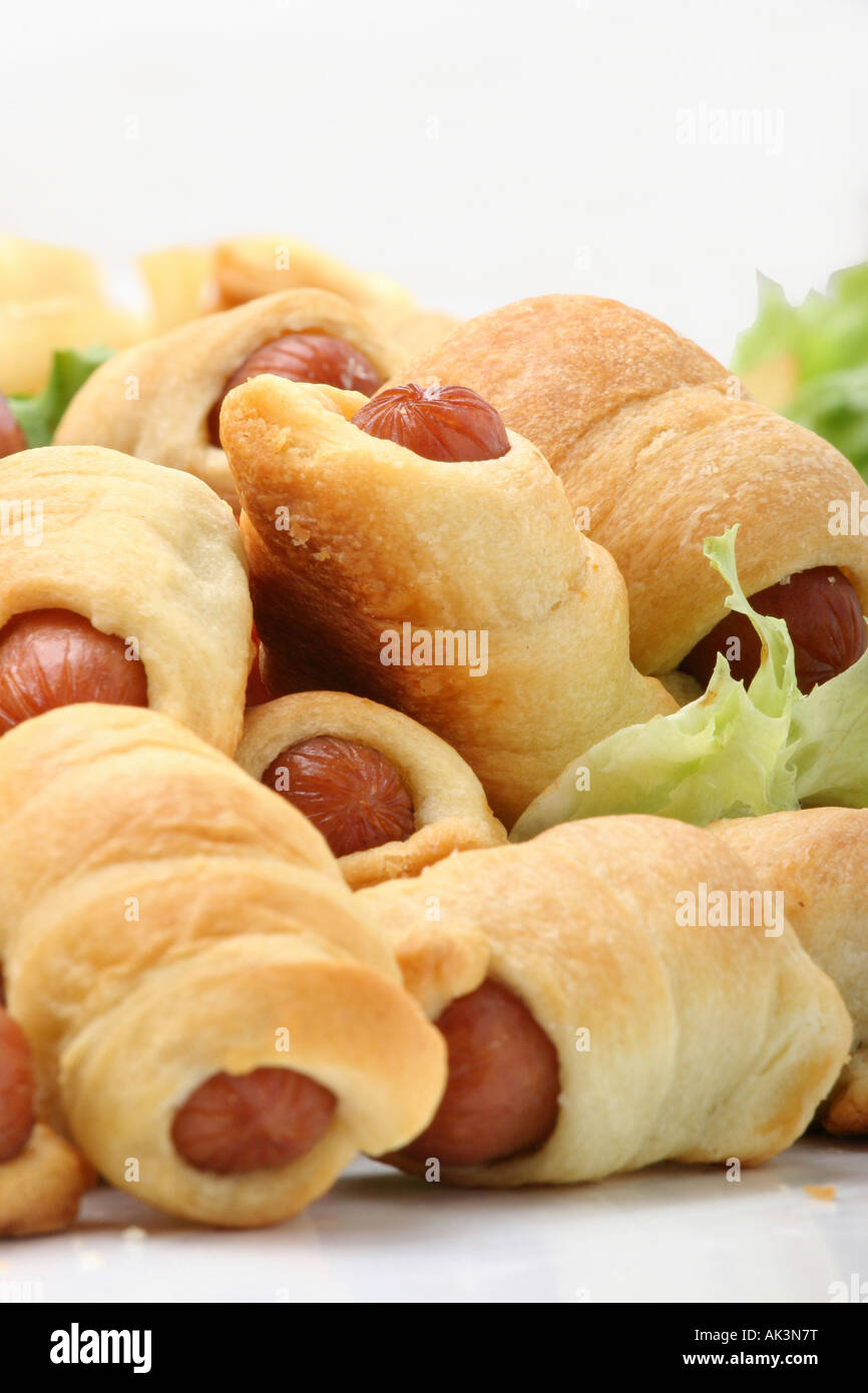 Mini sausage hot dog finger rolls from front view on white background ...