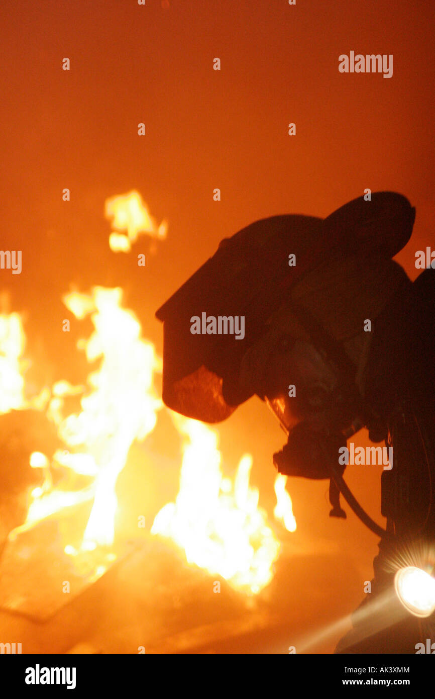 A fire fighter inspecting in a room of fire doing a search and rescue ...