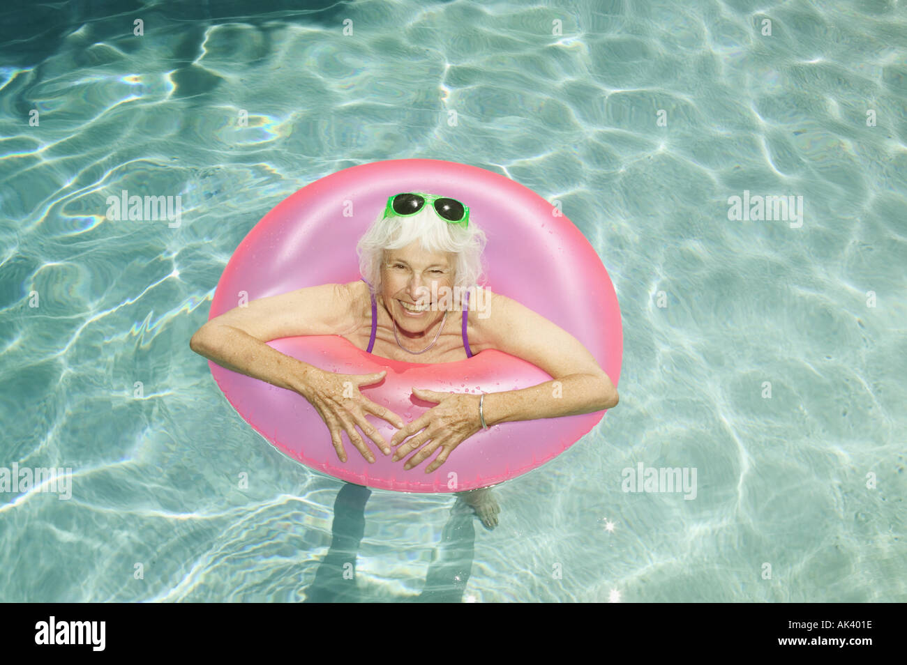 Senior woman floating in a swimming pool Stock Photo - Alamy