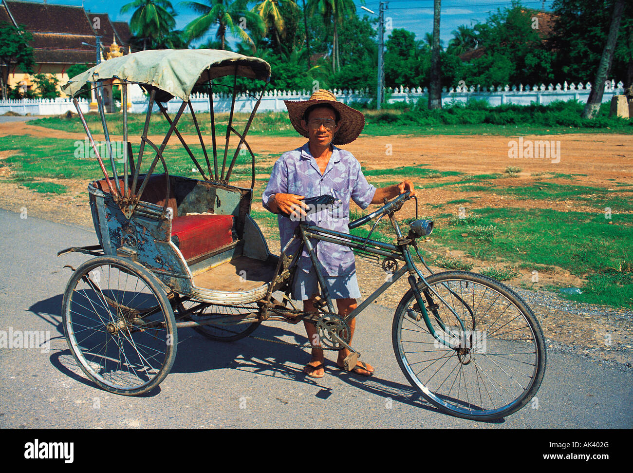 Laos. Cyclo driver (tricycle taxi Stock Photo - Alamy