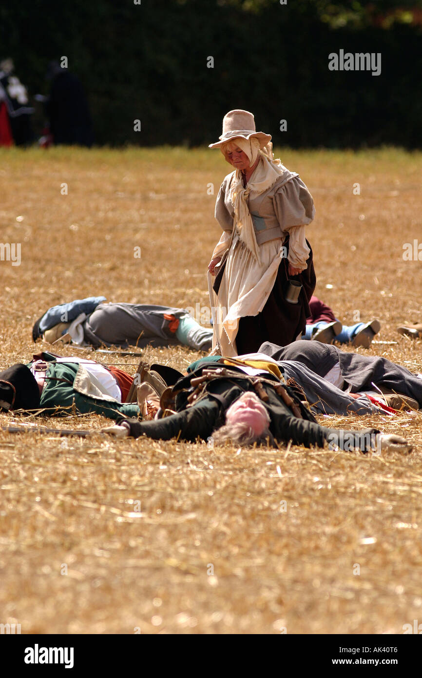 Camp follower amongst fallen soldiers at sealed knot civil war battle ...
