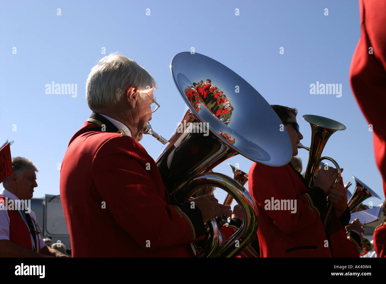 Man in red uniform playing tuba in brass band at local show UK Stock ...