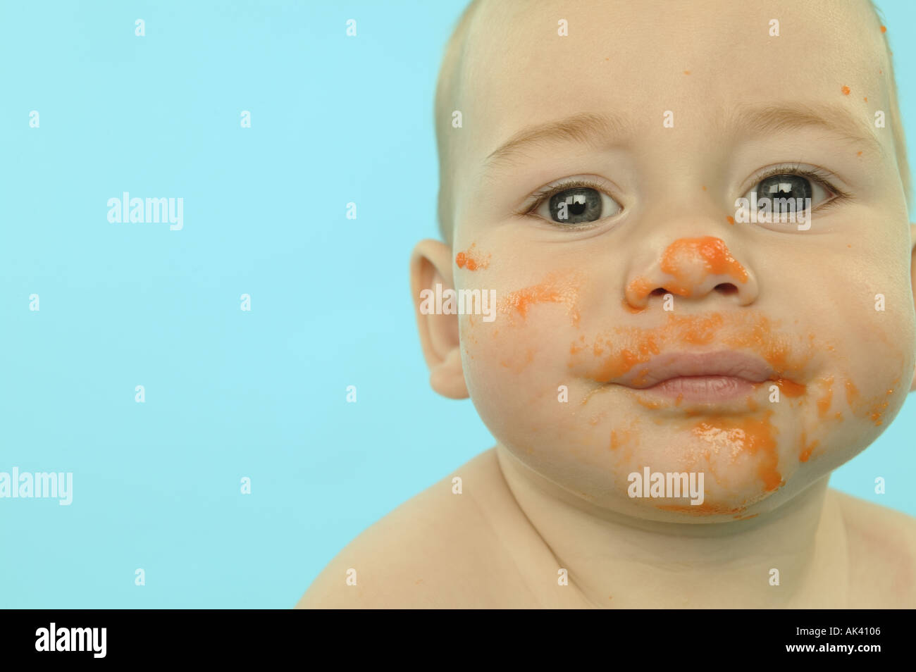 A baby with his face smeared with baby food Stock Photo - Alamy