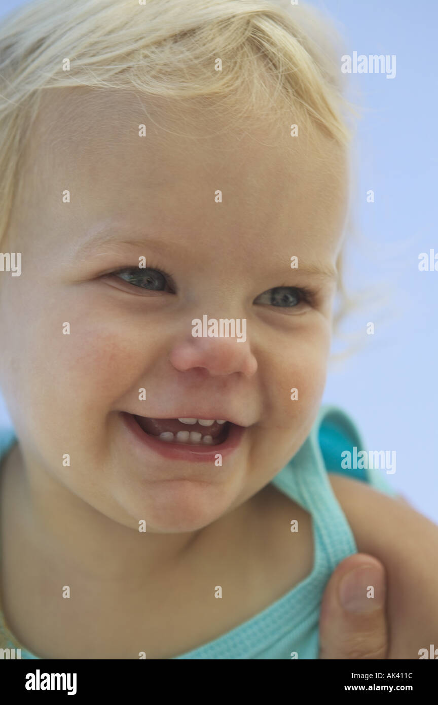 Caucasian baby girl with a parent s hand on her shoulder Stock Photo ...