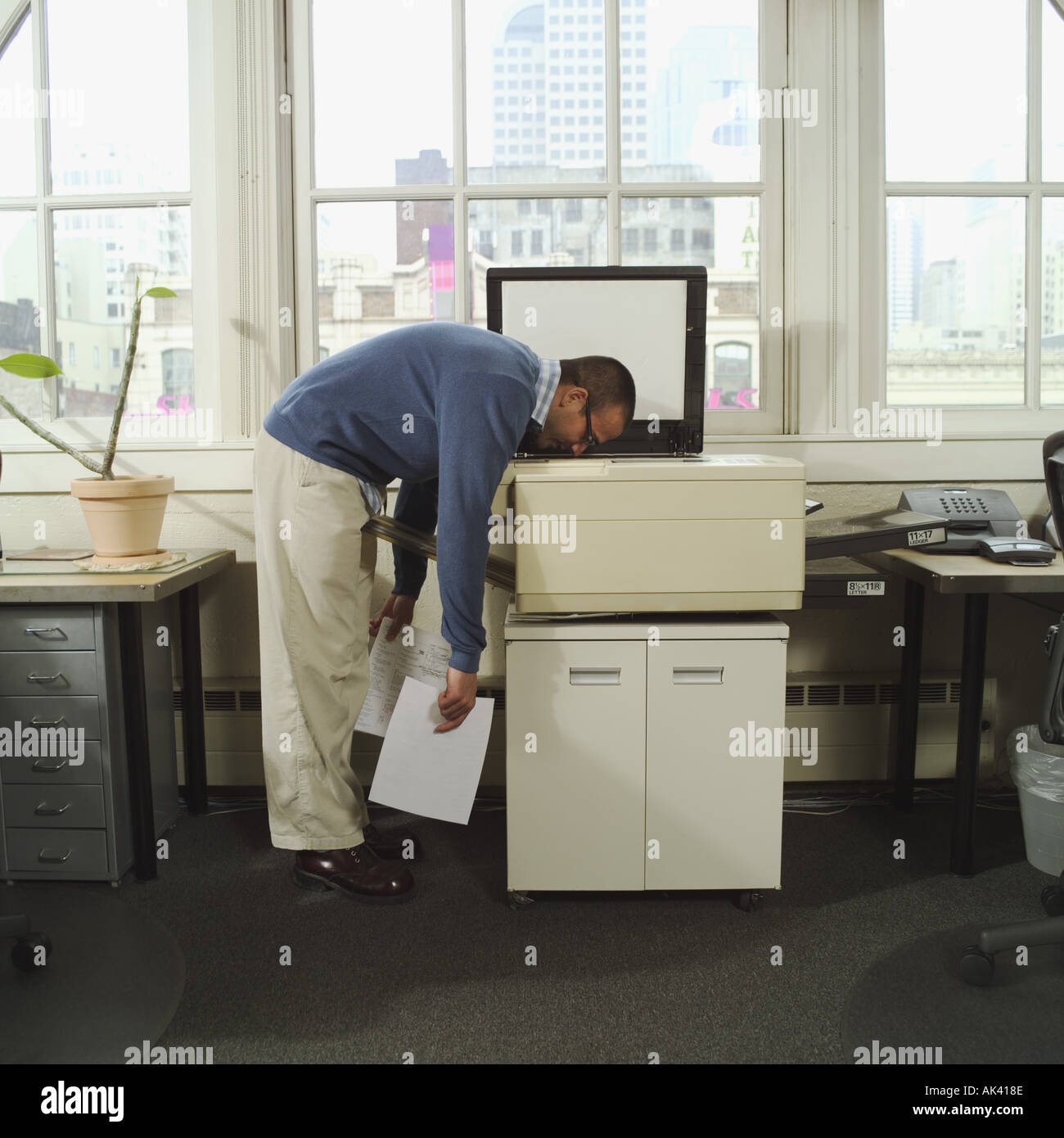 Photocopying man hi-res stock photography and images - Alamy